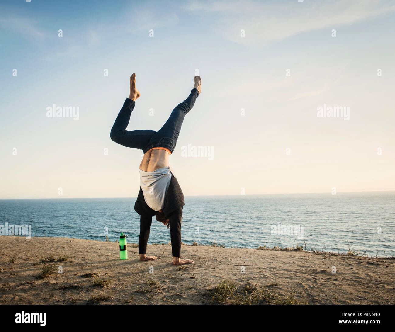 Man doing handstand on beach Stock Photo - Alamy