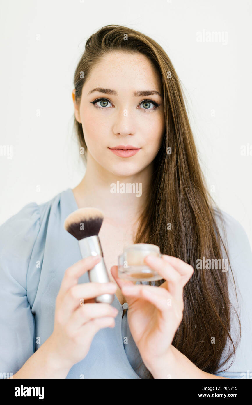 Woman holding brush looking hi-res stock photography and images - Alamy