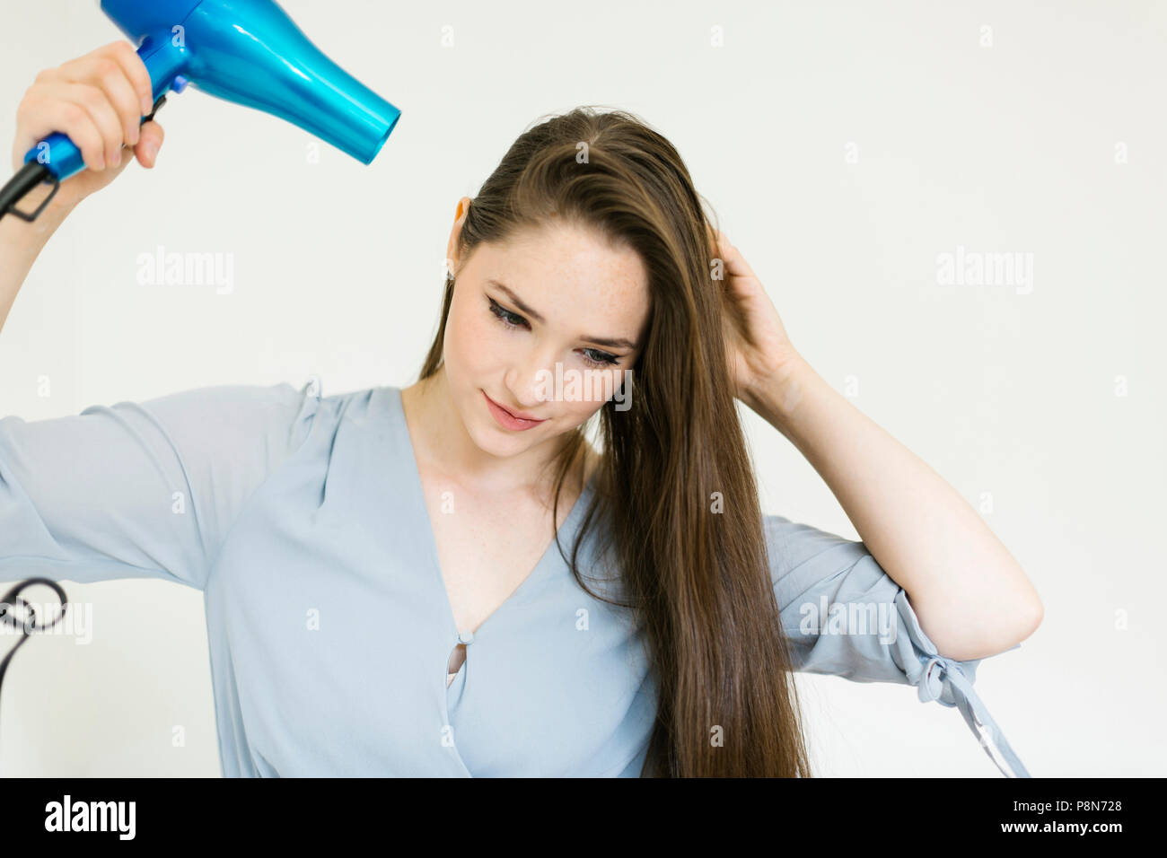 Woman using hair dryer hi-res stock photography and images - Alamy