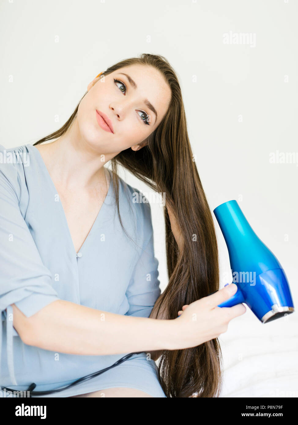 Woman drying hair using dryer hi-res stock photography and images - Alamy