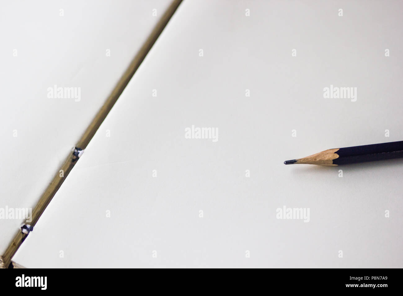 Opened notebook with pencil background with copy space. Black pencil on ...