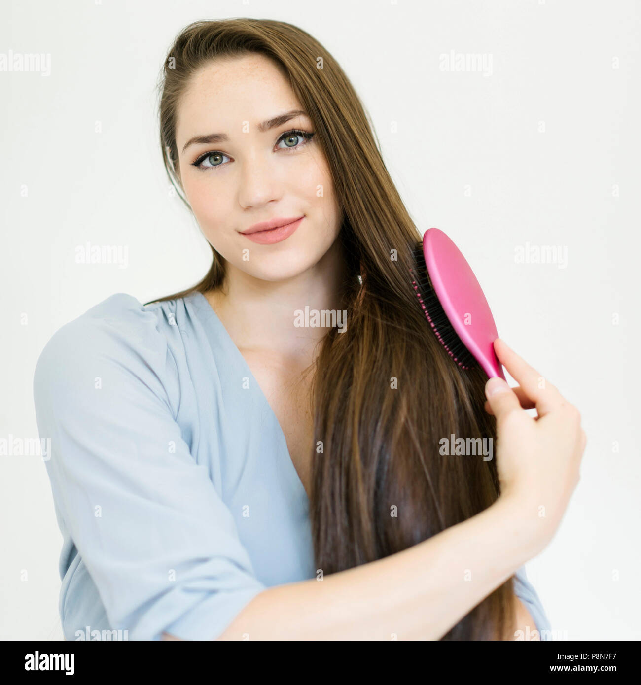 Woman brushing her hair Stock Photo - Alamy