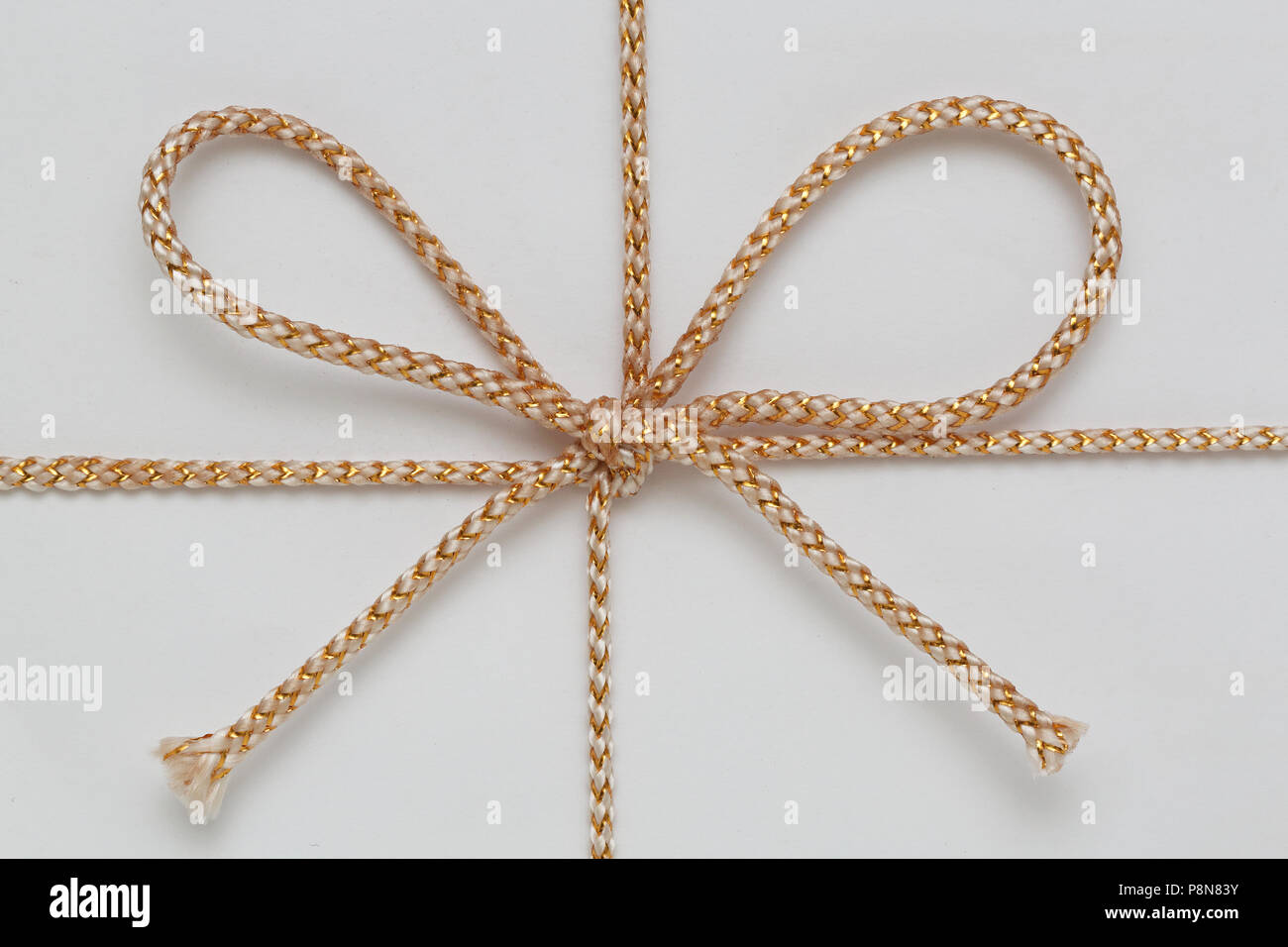 Small Gold String Bow at Gift Wrap Stock Photo - Alamy