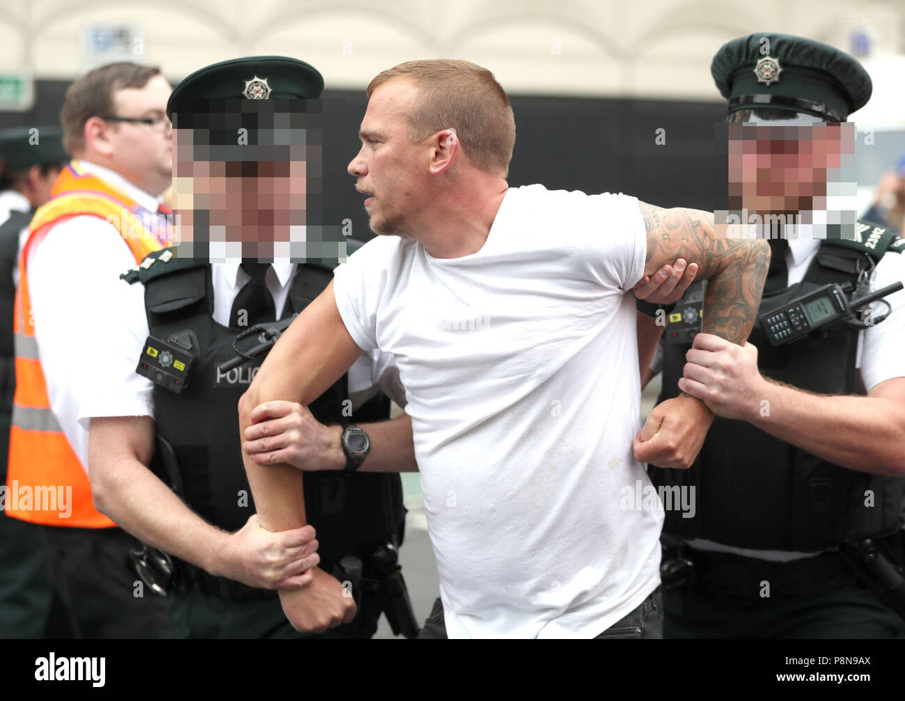 PIXELATED BY PA PICTURE DESK An onlooker at an Orange Order parade in ...