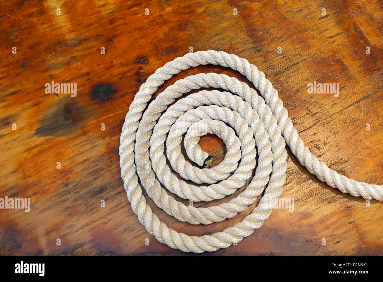 Coil of Rope at Wooden Boat Deck Stock Photo - Alamy