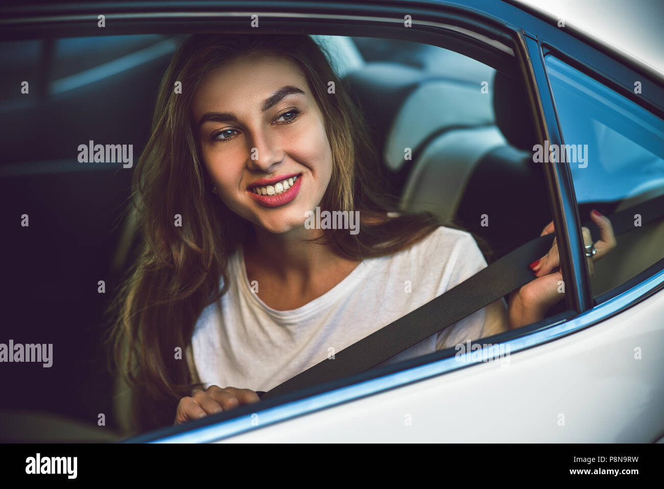 Beautiful Woman With Phone Smiling While Sitting On The Back Seat In