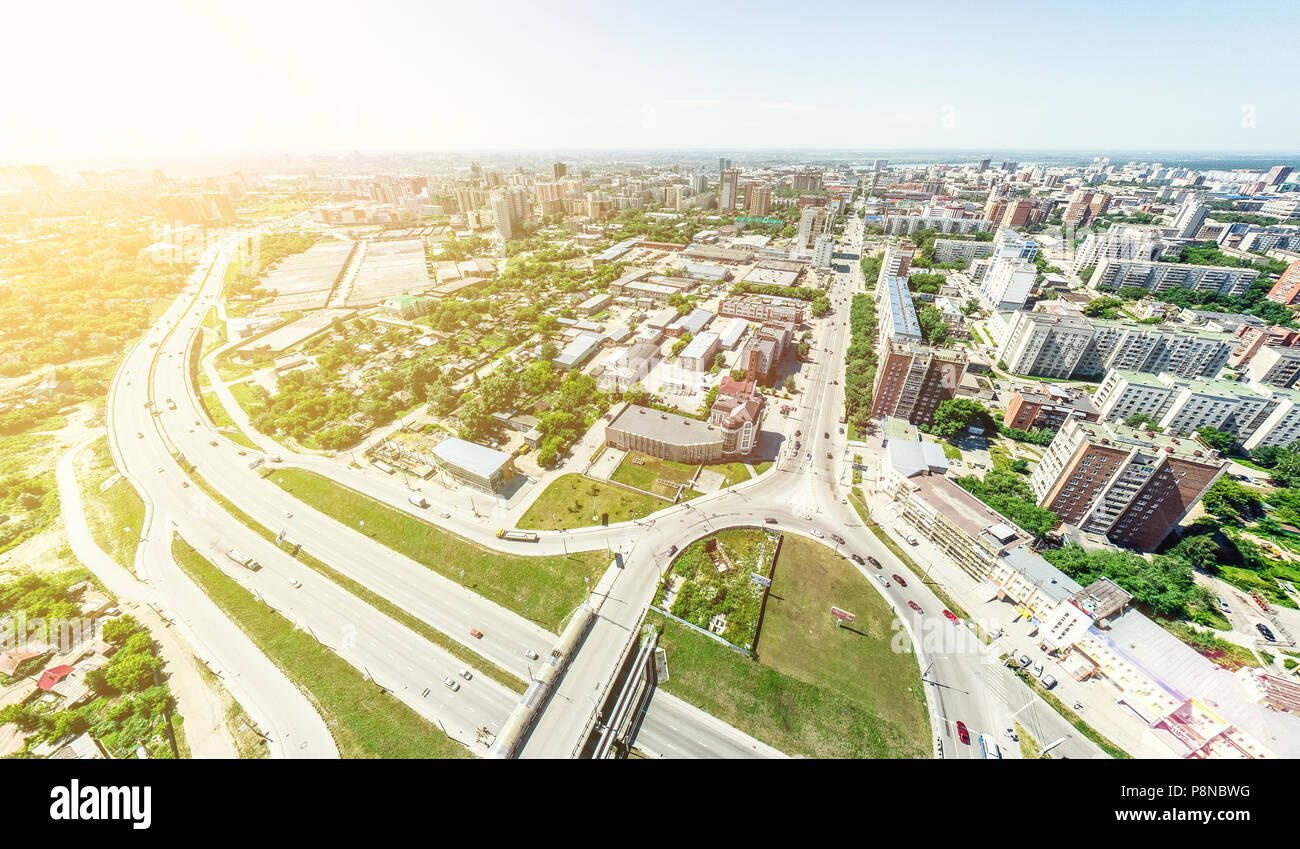 Aerial city view with crossroads and roads, houses, buildings, parks ...