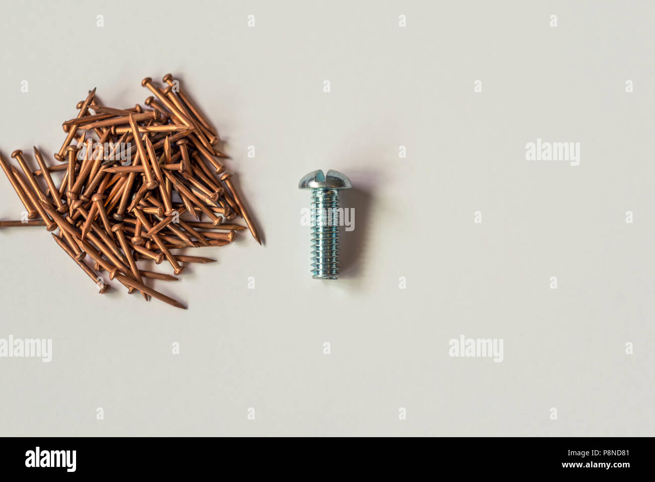 Close up of a group of bronze nails and a single metal screw Stock ...