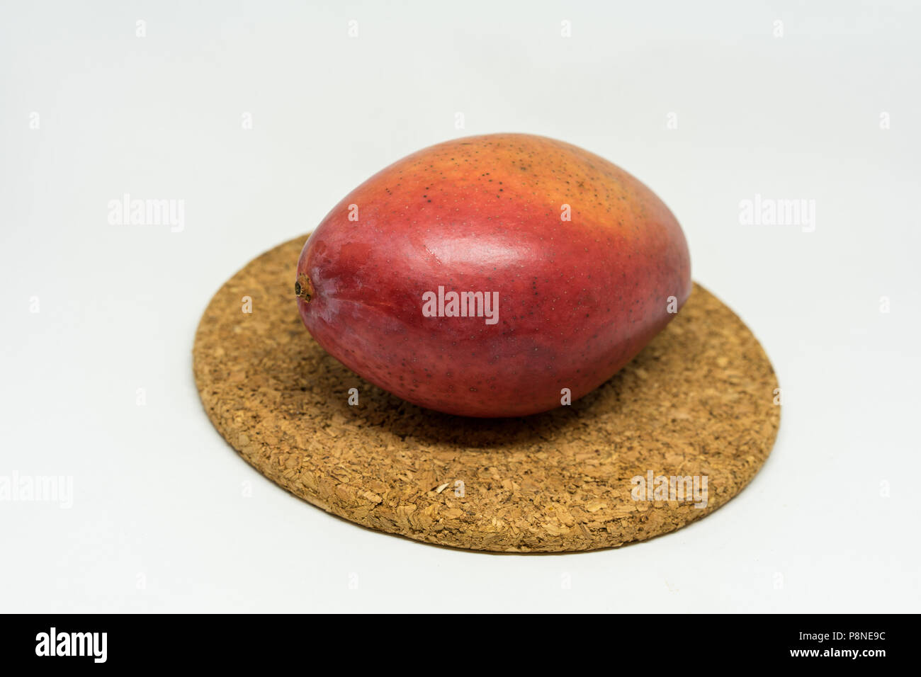 red mango fruit on cork isolated on white background Stock Photo - Alamy