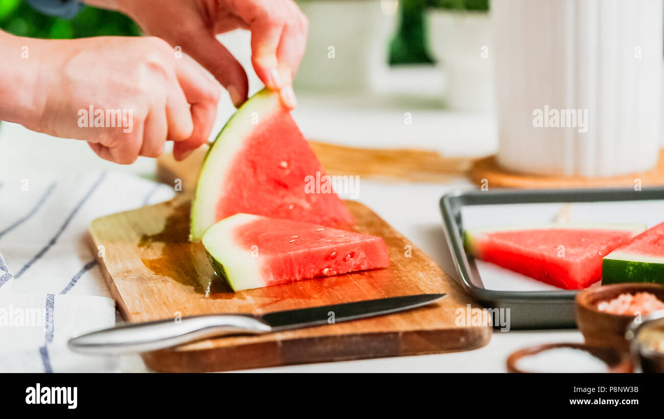 Step by step. Sliding the wood pop stick into the watermelon wage wedge ...