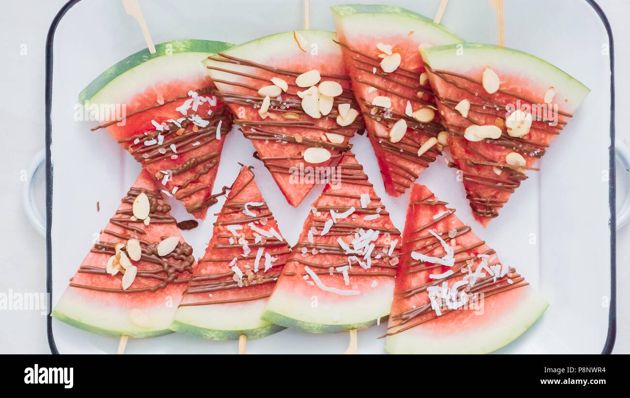Step by step. Watermelon wedges garnished with chocolate and sea salt ...
