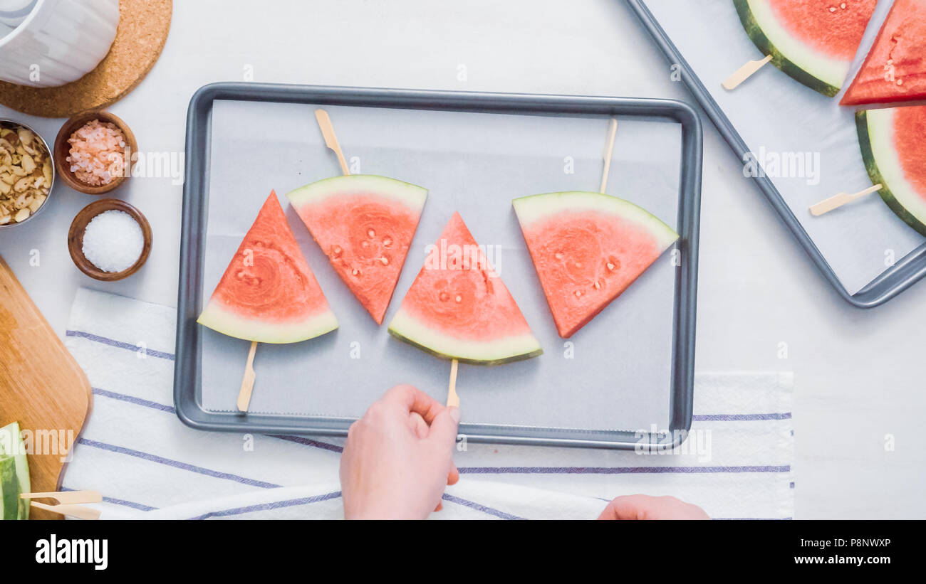 Step by step. Watermelon wedges on a wooden stick on baking sheet Stock ...