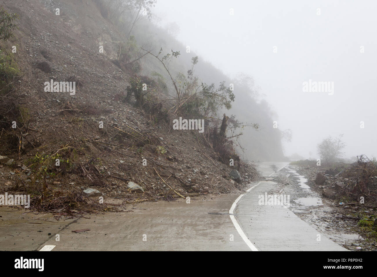 Landslides caused by excessive rainfall nearly block the road Stock ...