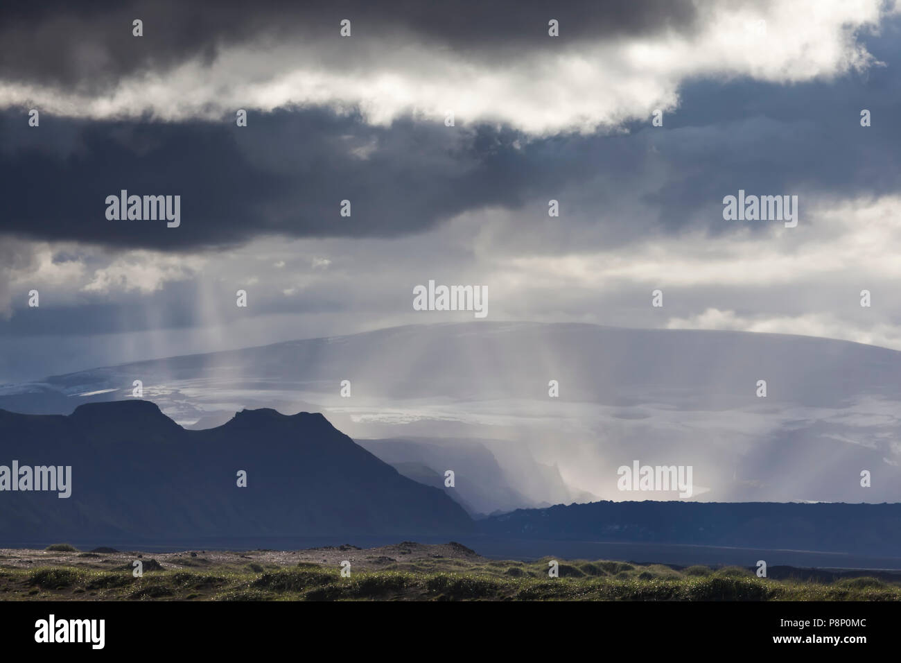 Rain falling from dark clouds under a different angle than the suns ...