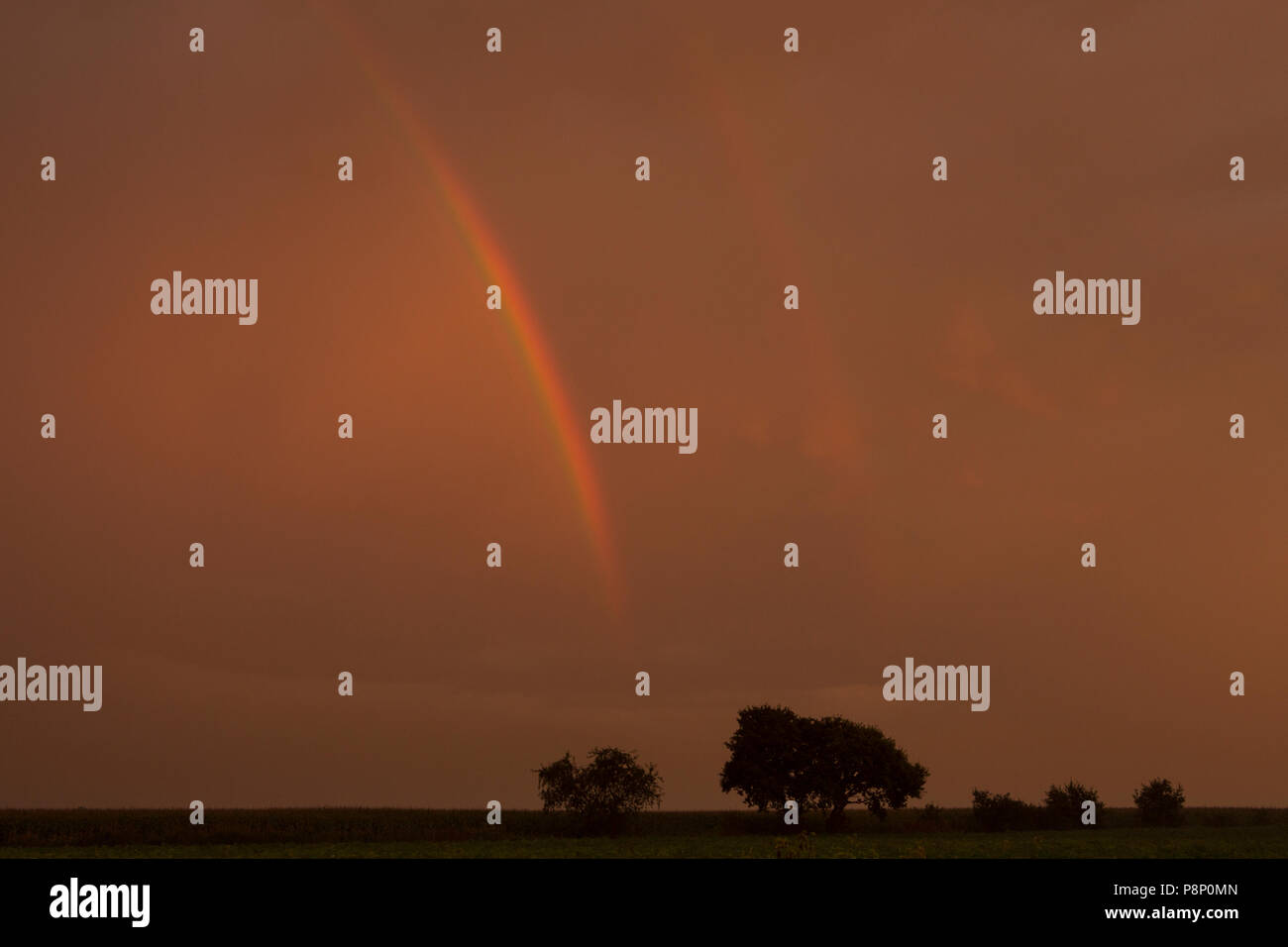 During sunset the sky and rainbow turn red Stock Photo - Alamy