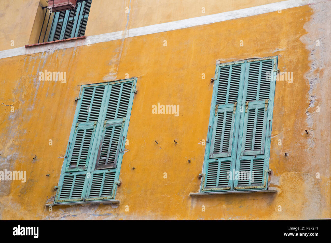 Windows with mediterranean style shutters on them Stock Photo - Alamy