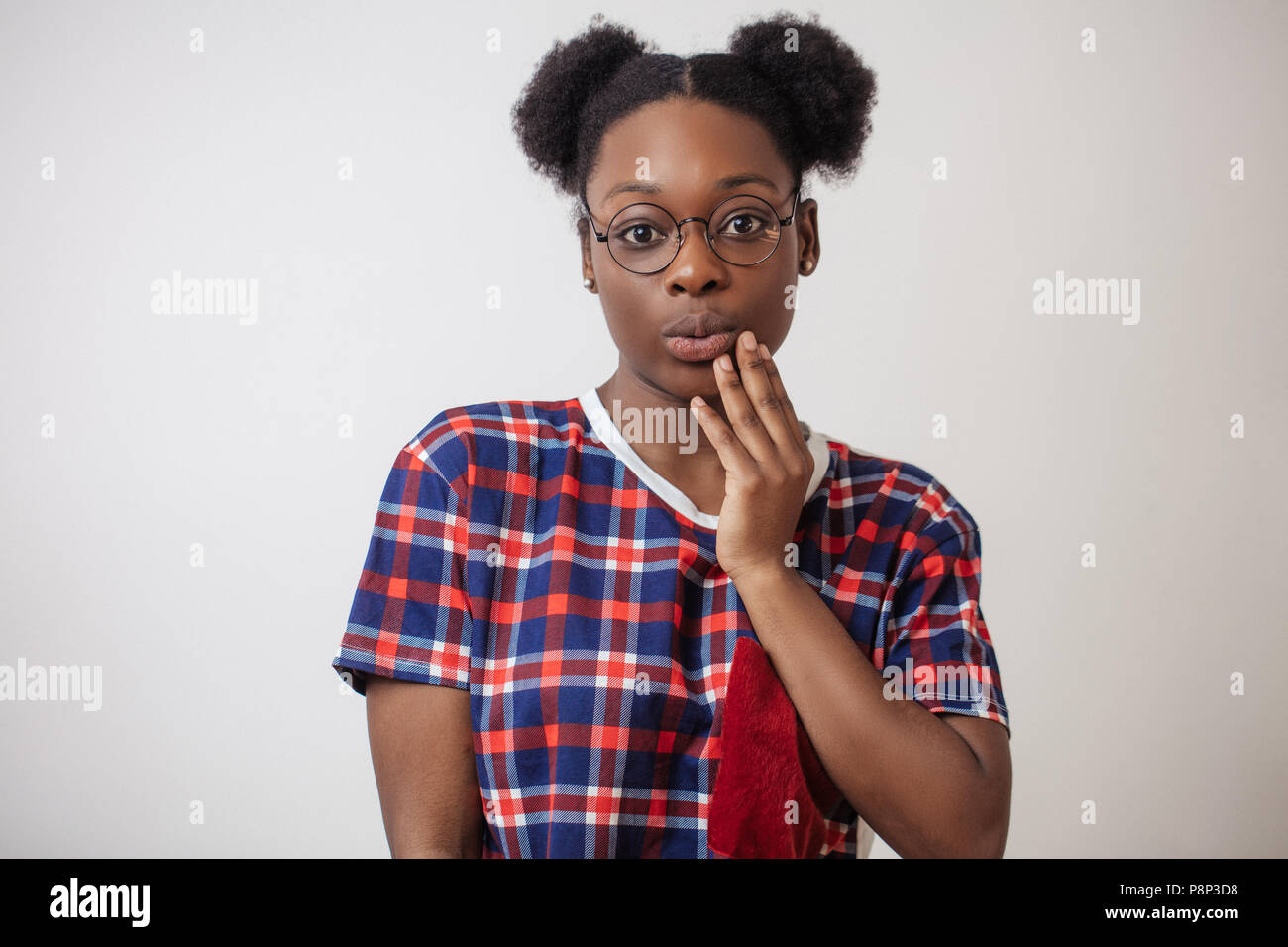 close up portrait of African woman with surprised look touching her ...