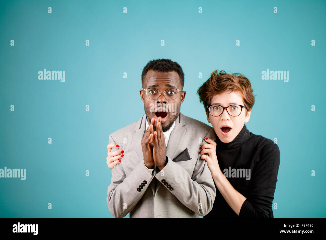 close up portrait of two young people watching horror film. surprising ...