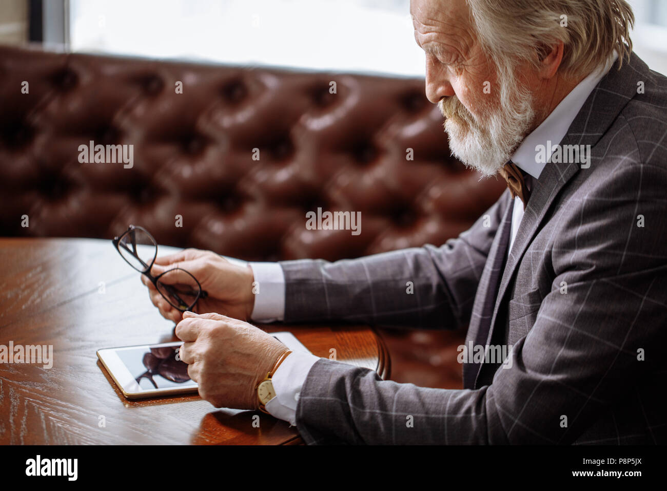 Mature man sitting round table hi-res stock photography and images - Alamy