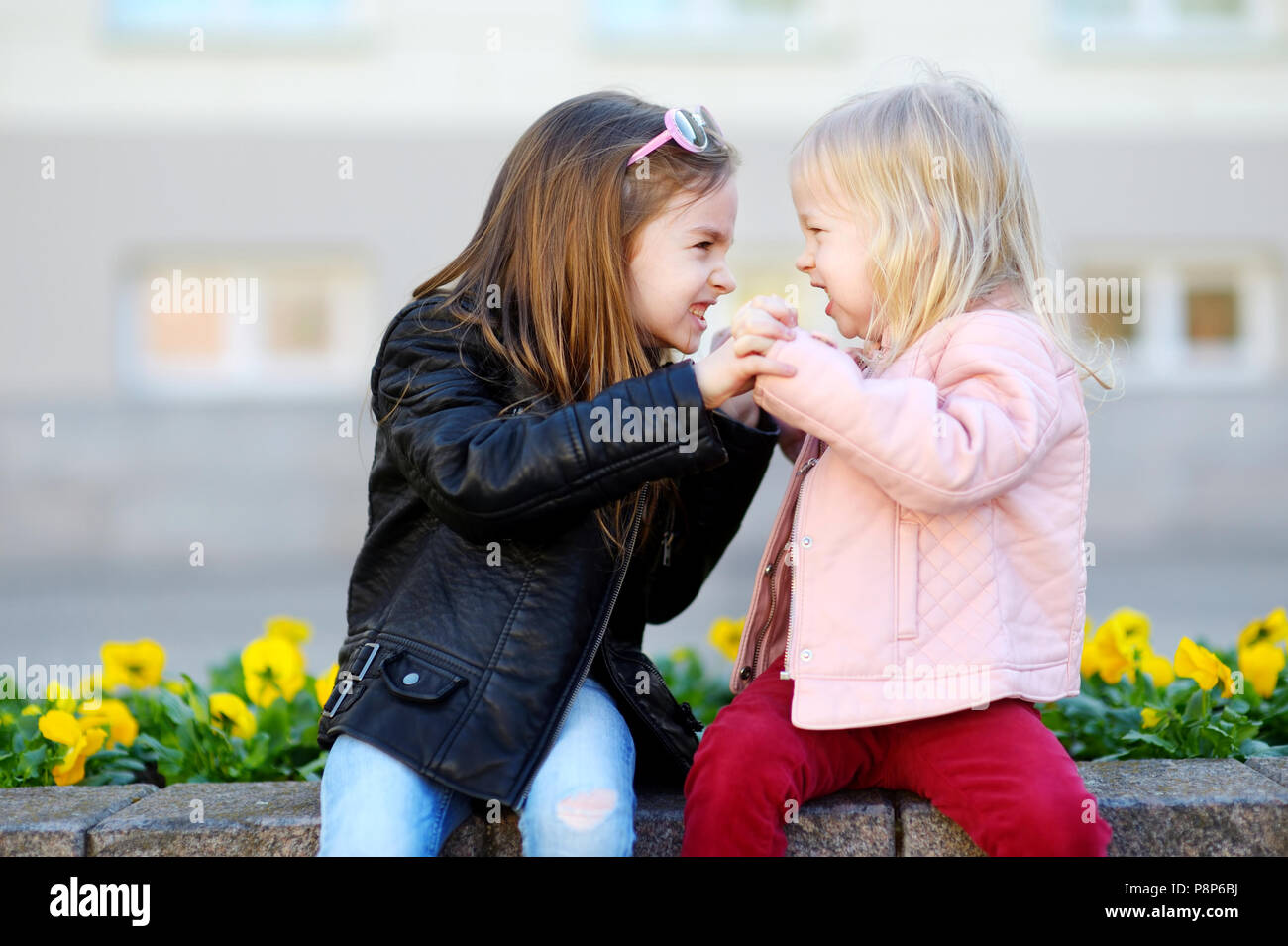 Two little sisters fighting outdoors Stock Photo - Alamy