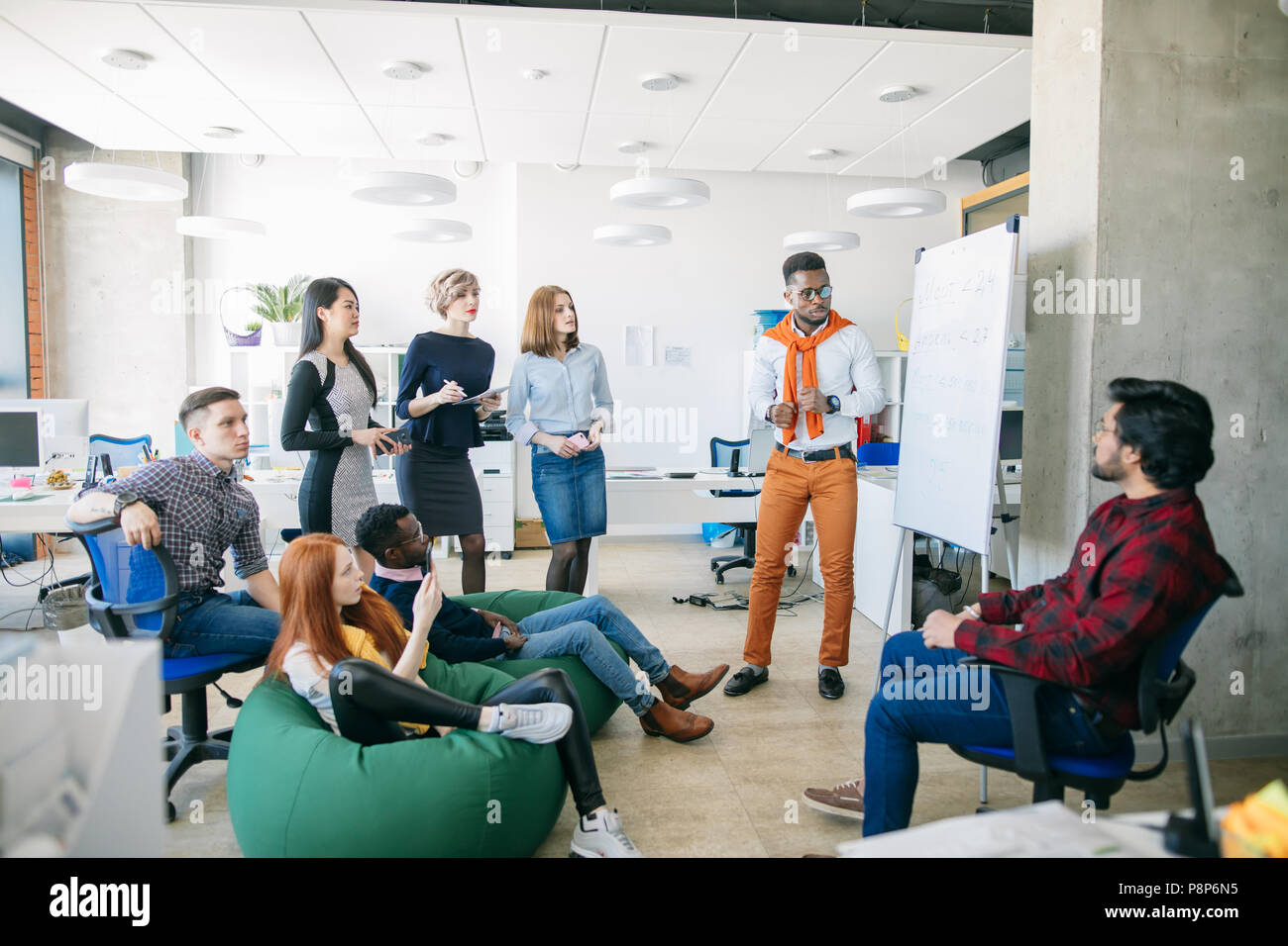 african fashionable leader is holding a seminar for multi ethnic staff ...