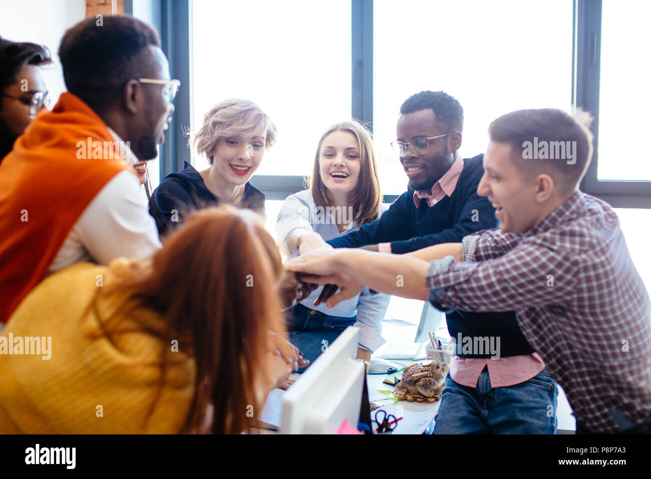 close up cropped portrait of positive youth putting arms together Stock ...
