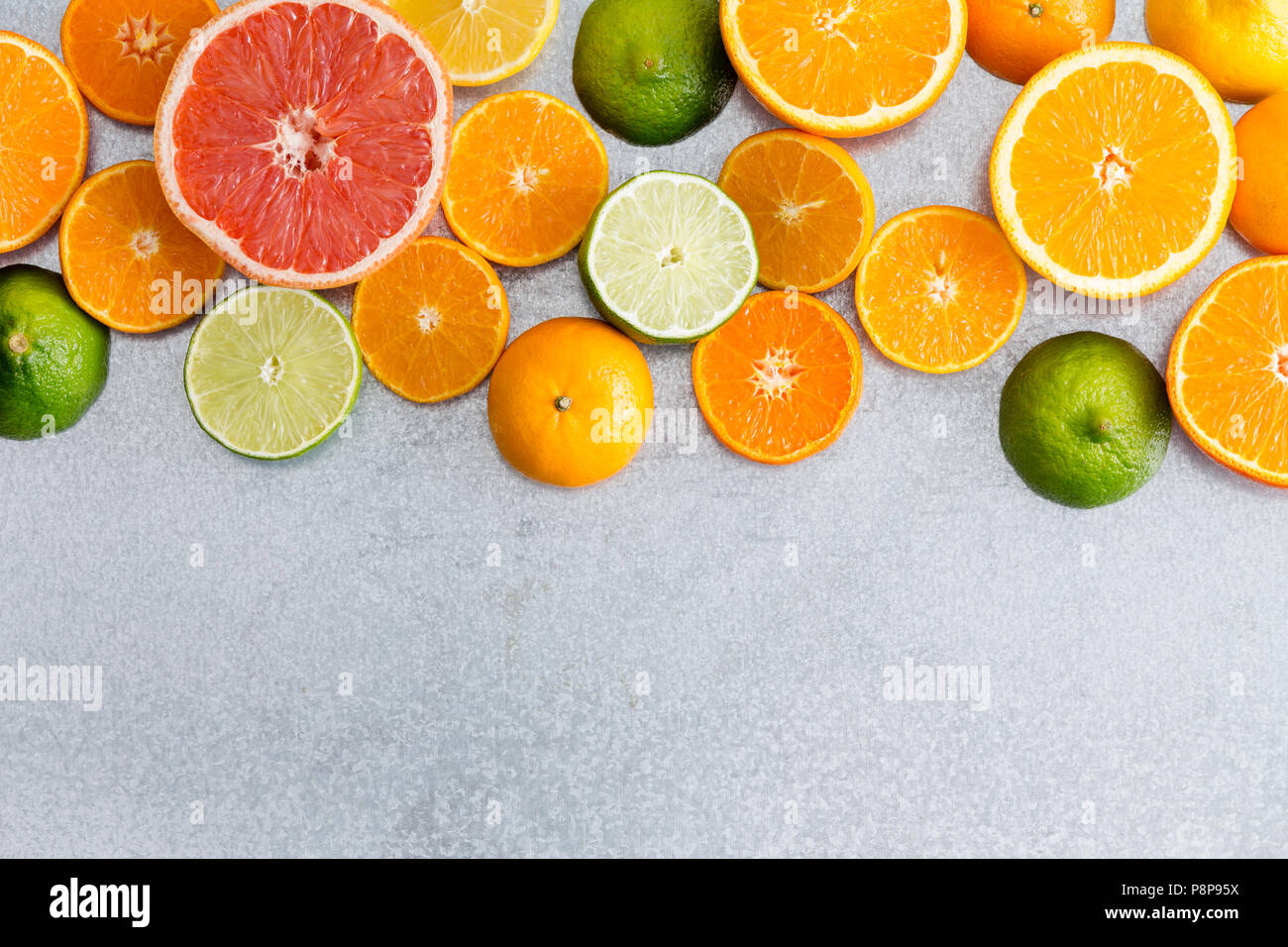 Mixed still life border of colorful fresh cut citrus fruit with oranges ...