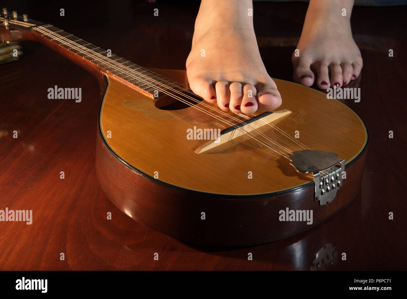 lady foot on mandolina Stock Photo - Alamy