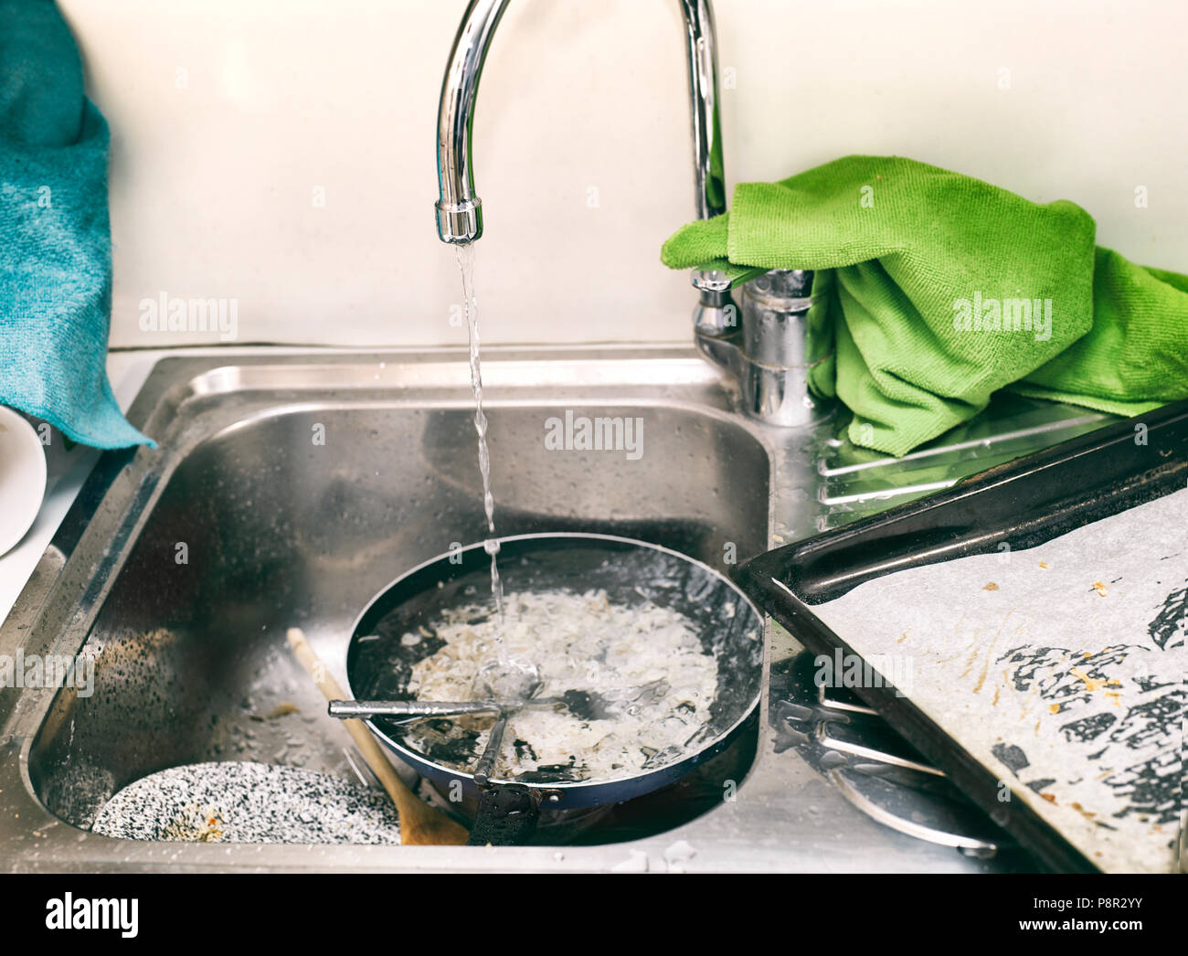 Messy kitchen sink loaded with dirty dishes, filtered shot Stock Photo ...