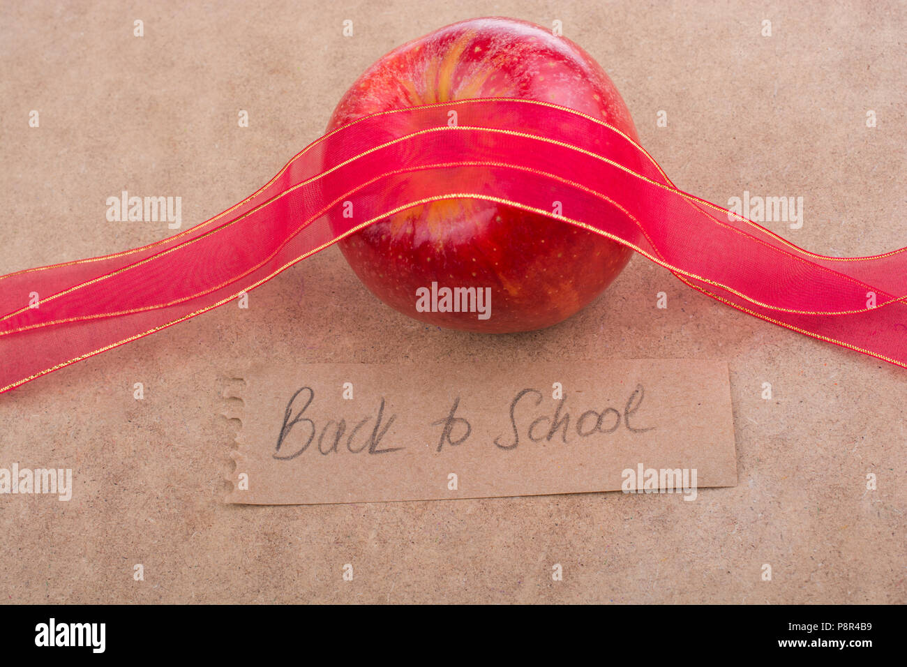 Back to school lettering with apple and a red ribbon Stock Photo - Alamy