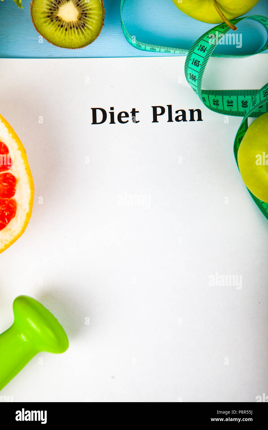 Food and sheet of paper with a diet plan on a blue wooden background ...