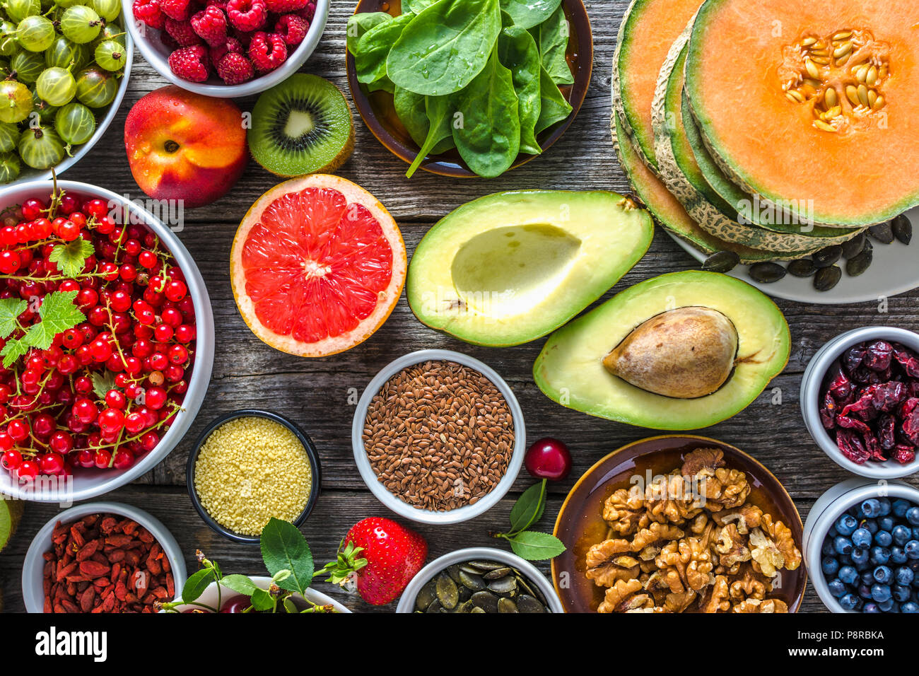 Healthy food on table, fruit assortment, nuts and seeds, superfoods ...