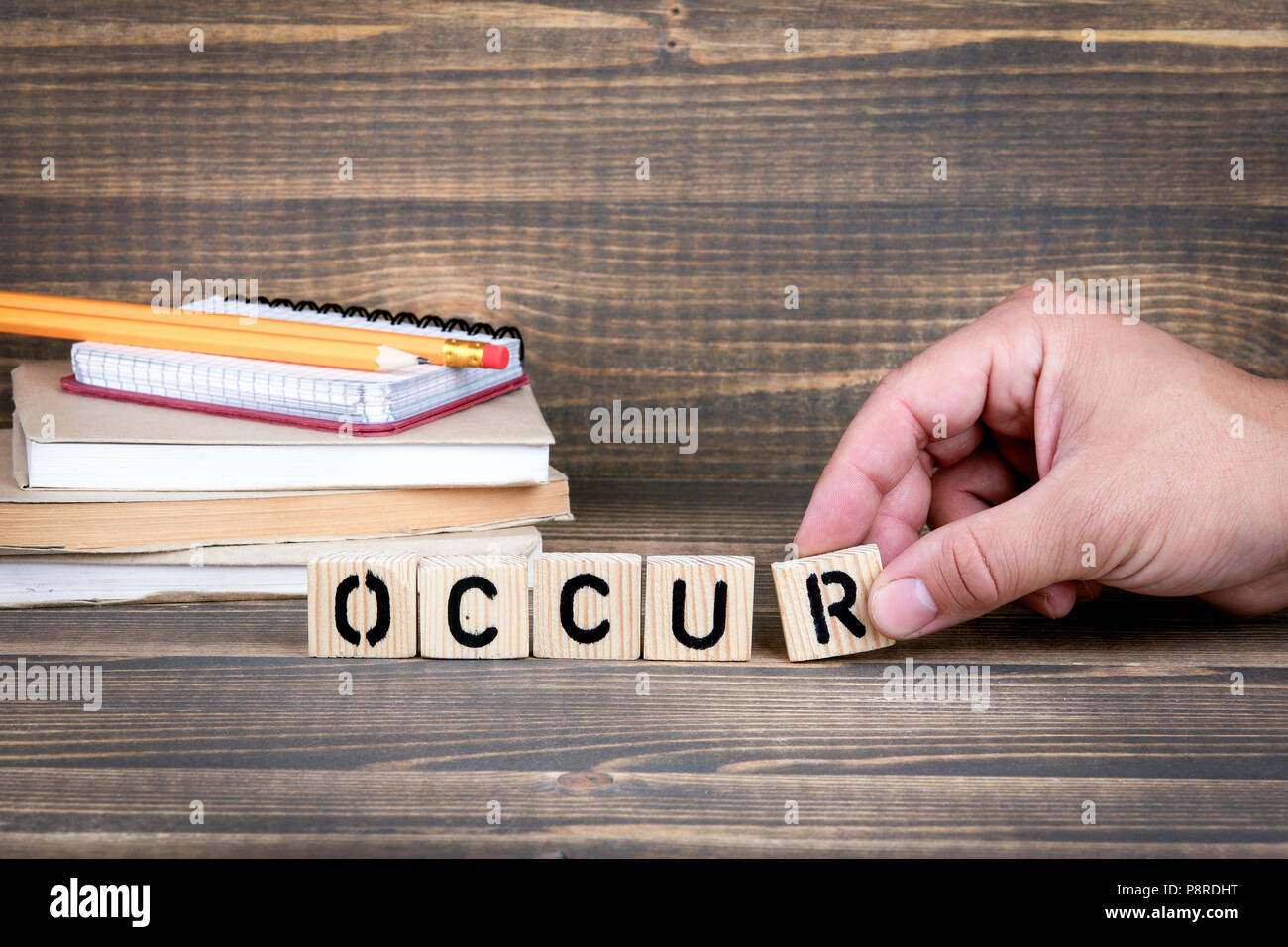 Occur. Wooden letters on the office desk, informative and communication ...