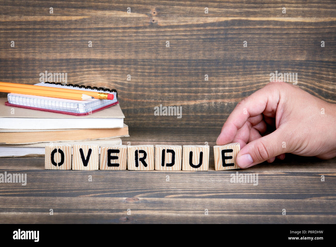 Overdue. Wooden letters on the office desk, informative and ...