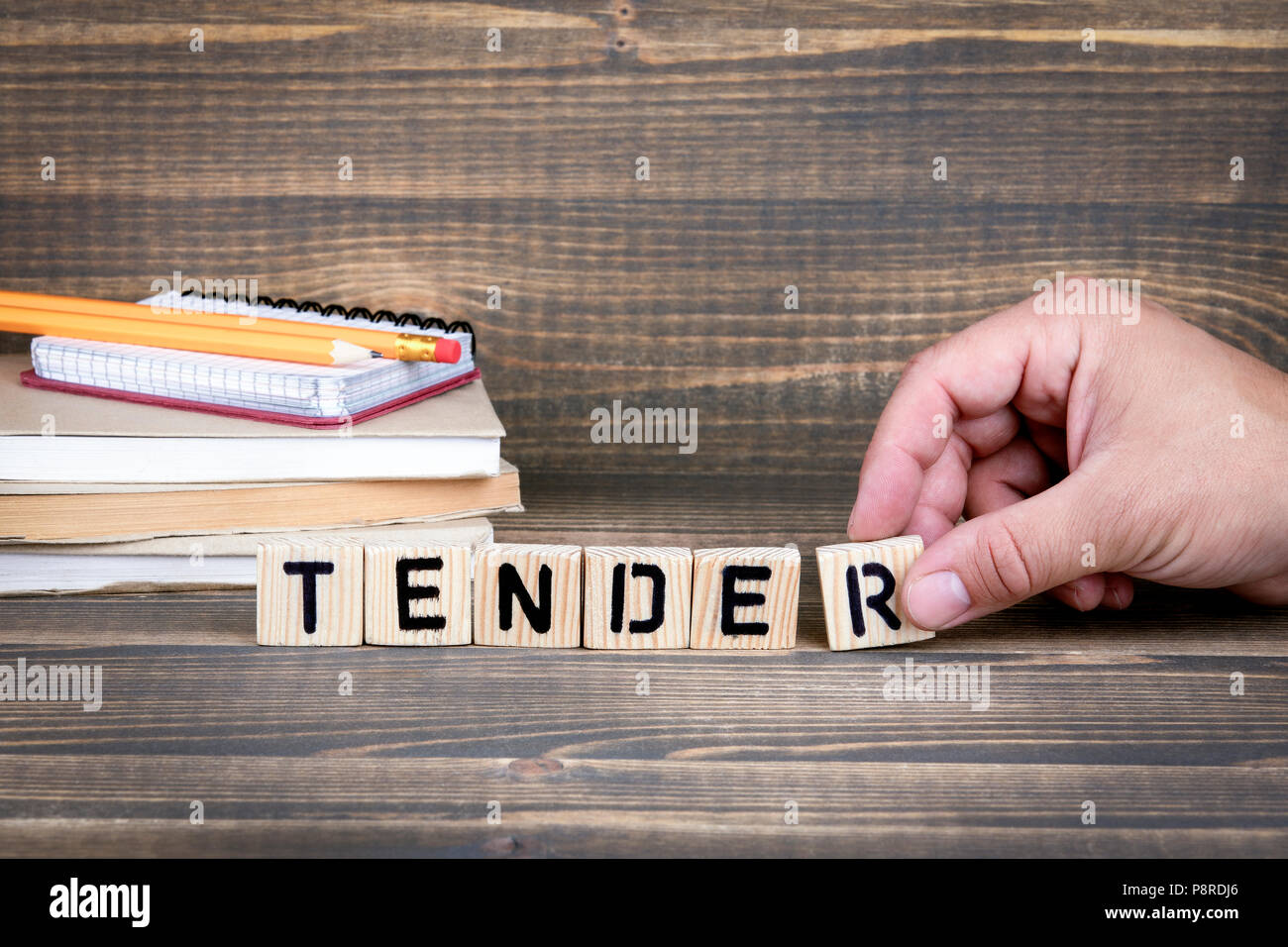 Tender. Wooden letters on the office desk, informative and ...
