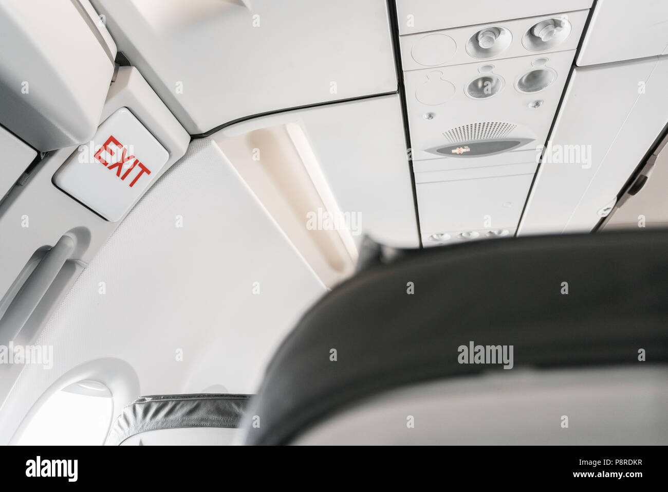 emergency exit sign on airplane. Empty airplane seats in the cabin ...