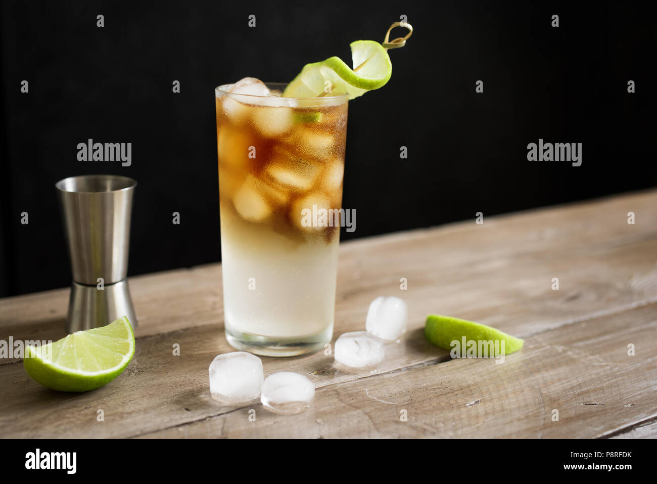 Dark and Stormy Rum Cocktail with Ginger Beer and Lime garnish. Glass ...