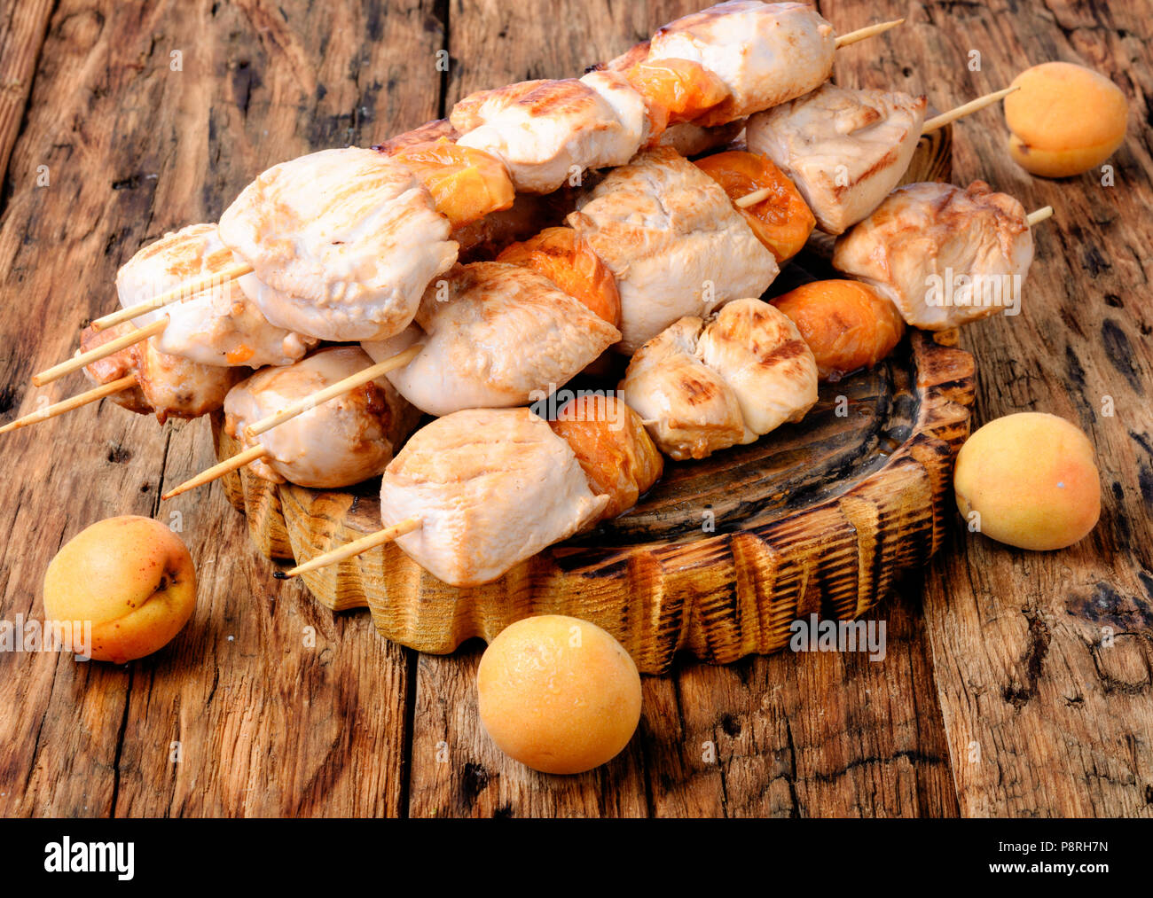 Turkey meat on barbecue grill,cooked on skewers with apricot .BBQ Stock ...