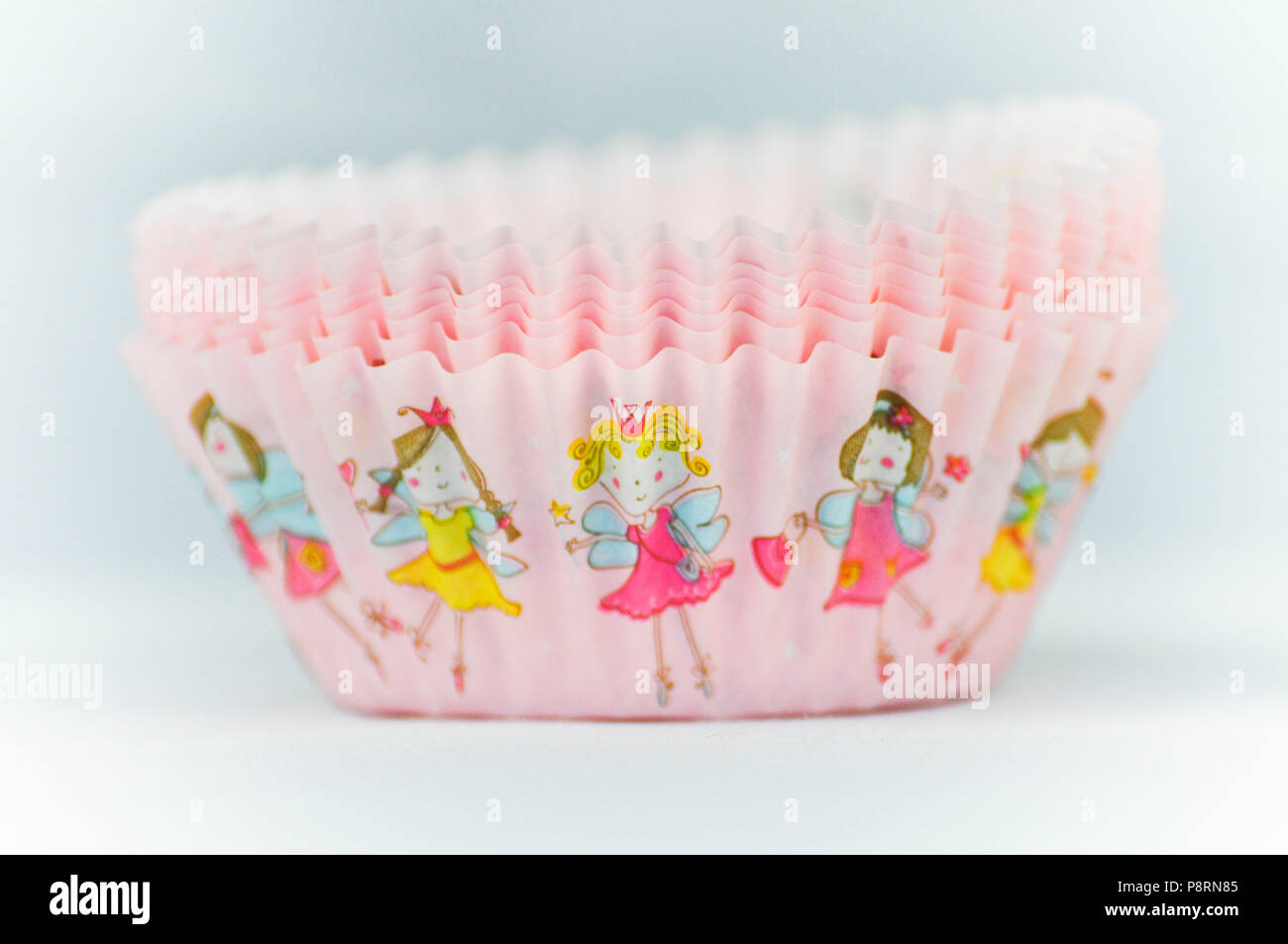 Pink bun cases with fairies Stock Photo - Alamy