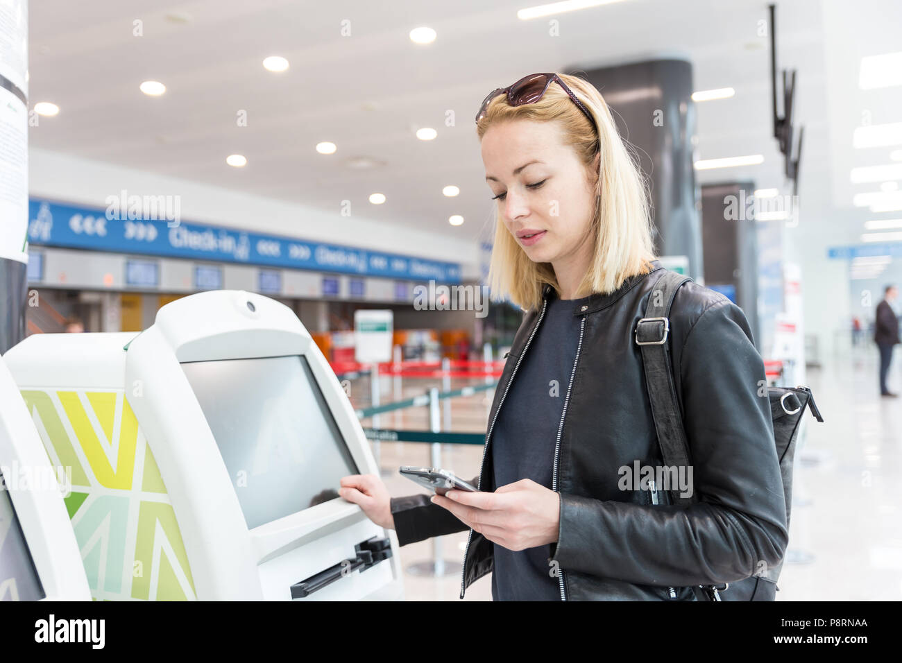 Casual caucasian woman using smart phone application and check-in ...