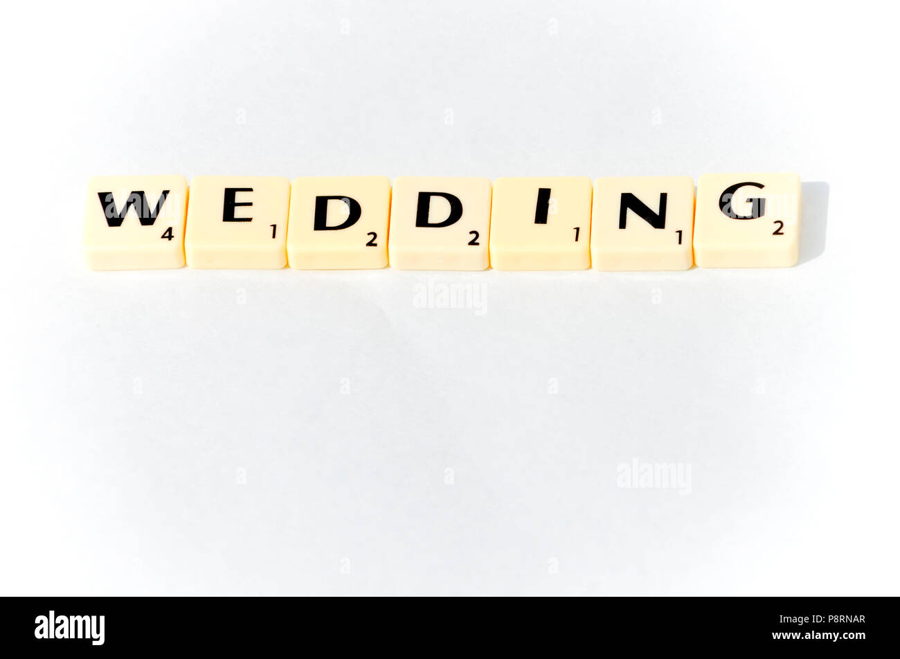 the word ' WEDDING' spelt out using scrabble letters. Set against a ...