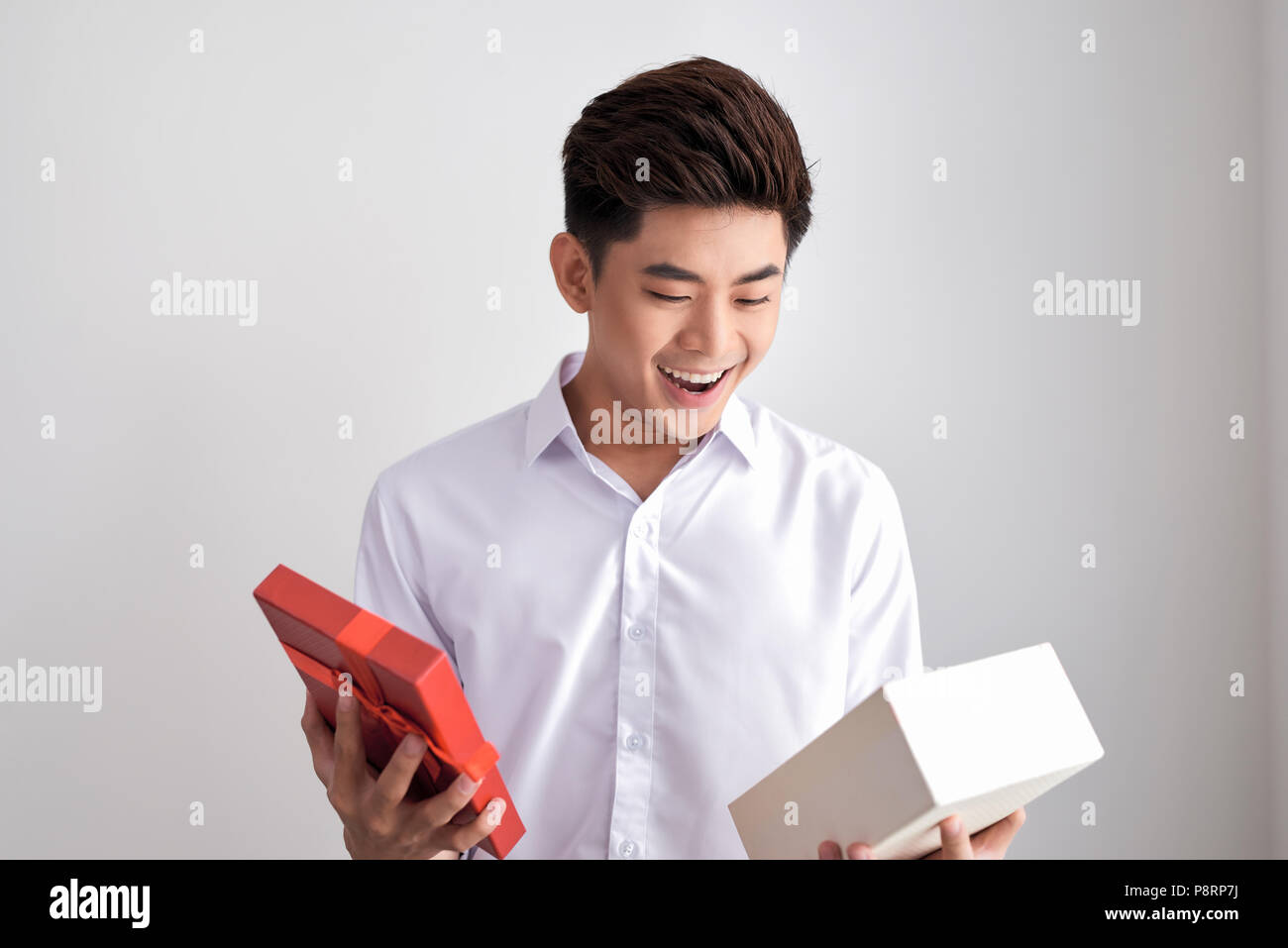 Handsome beard young man smiling and opening a brown gift box, guy ...