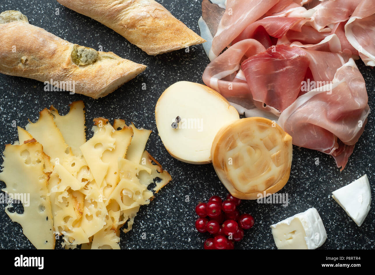 Cold appetizer. Cold cuts. Spicy food on black background Stock Photo ...