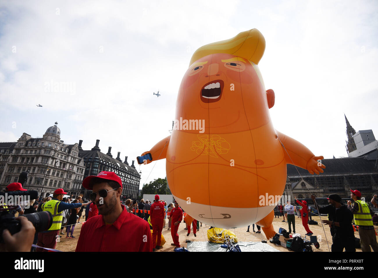 US Marine helicopters pass the 'Baby Trump' balloon as it rises after ...