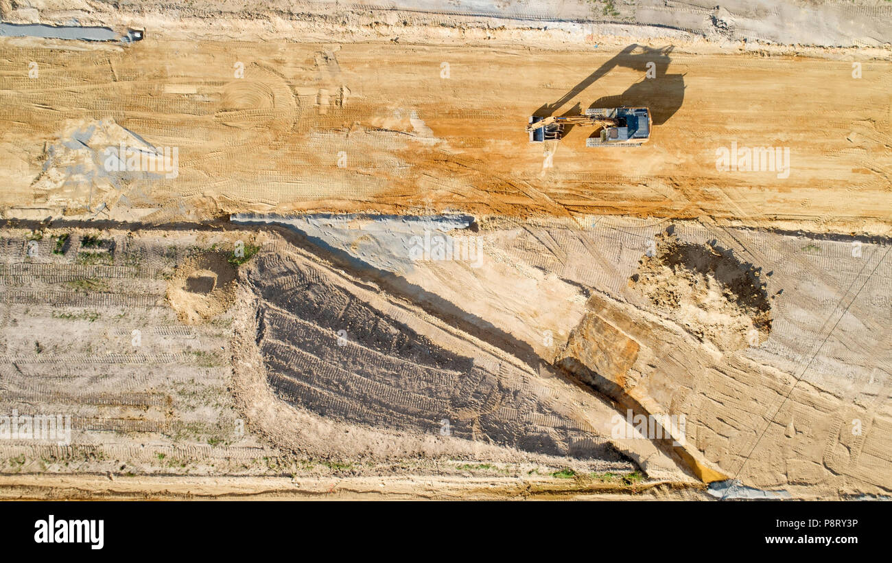 Aerial photo of a backhoe on a construction site Stock Photo - Alamy