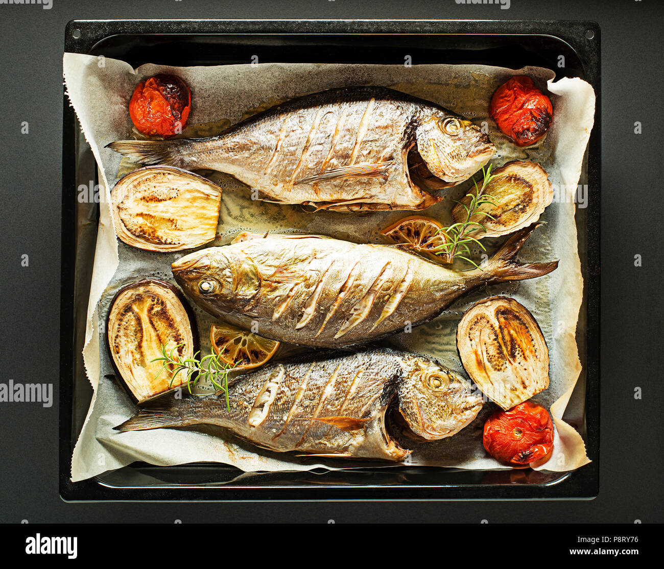 Grilled Gilt-head bream fish with vegetables and spices Stock Photo - Alamy