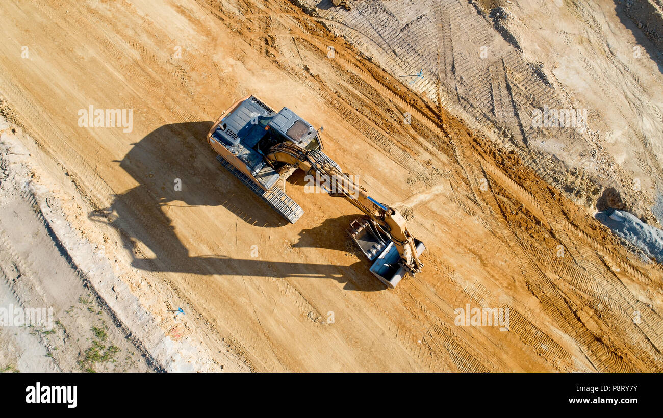 Aerial photo of a backhoe on a construction site Stock Photo - Alamy