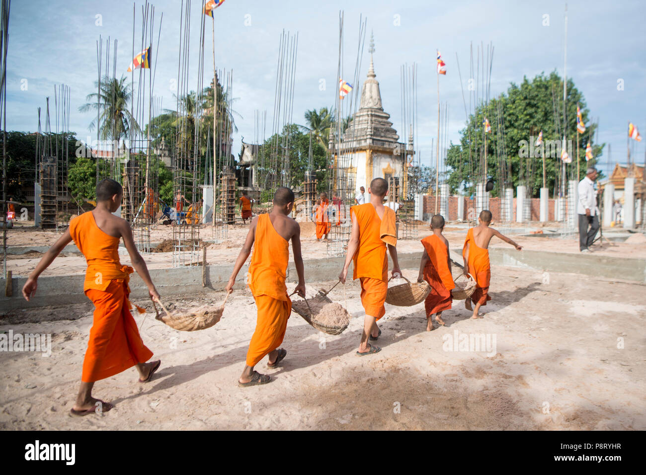 young monks wort at a construction for a new building at the Wat ...