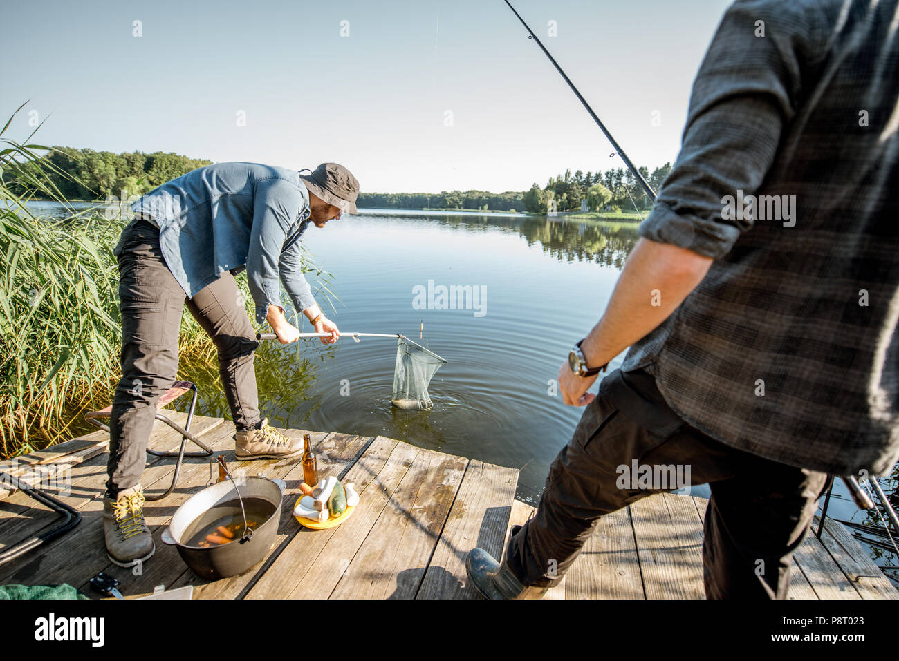 Man with big fish in net hi-res stock photography and images - Alamy