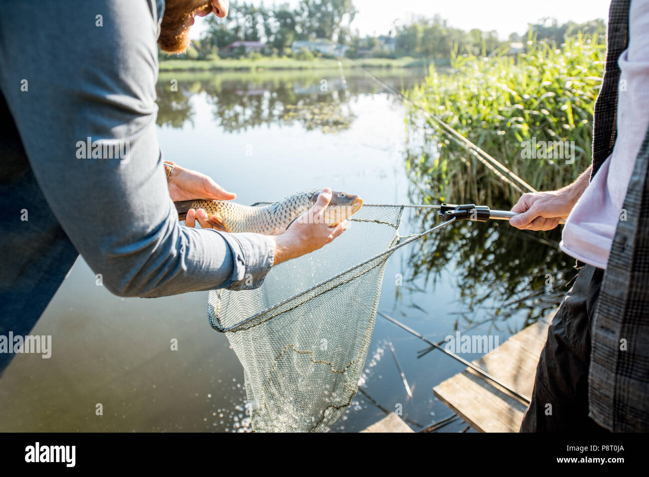 Male hands holding fresh caught hi-res stock photography and images - Alamy
